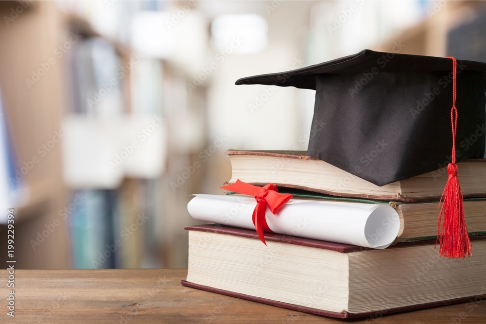 Graduation hat on stack of books Stock Photo | Adobe Stock