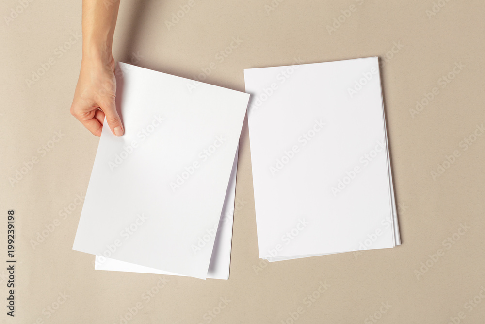 Hand holding papers a4 size Stock Photo | Adobe Stock