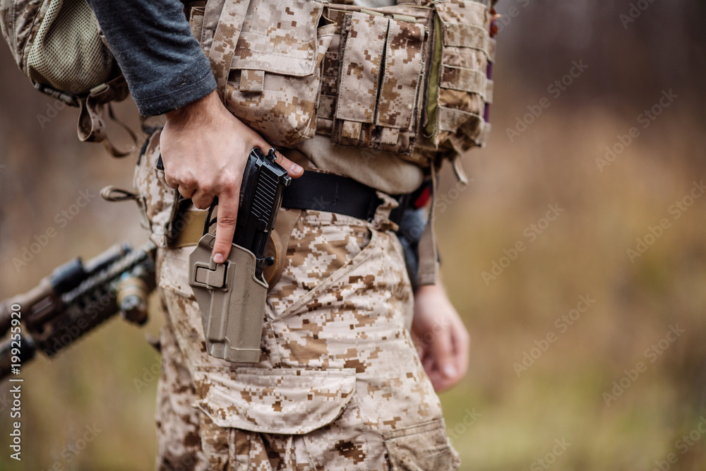 Ranger wearing uniform with gun in hand,keep gun in the holster ...