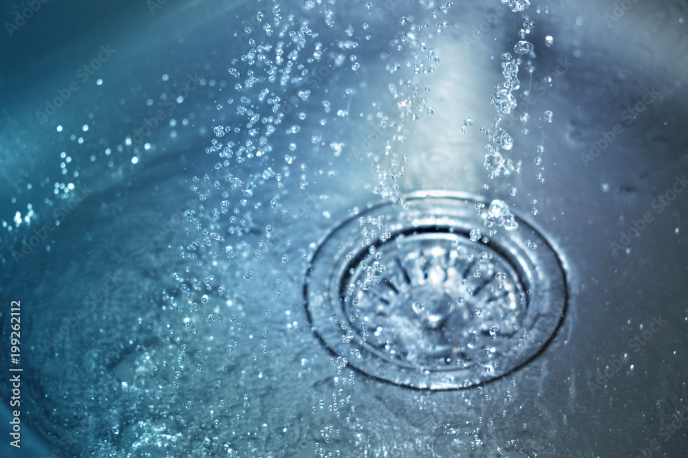 Water supply problem. Water flow. Small drops of water from a tap on ...