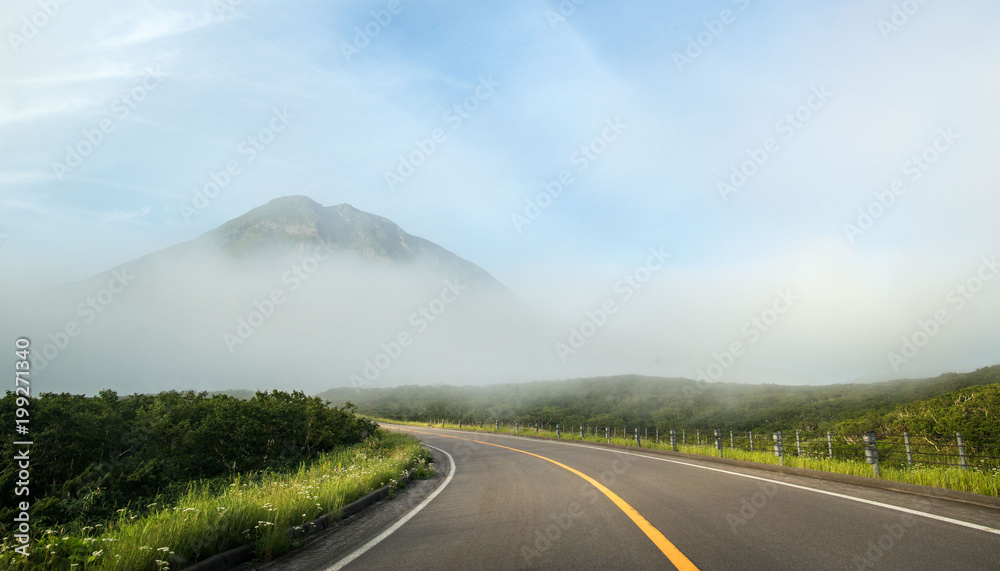 Mt. Rausu towers above the fog in Shiretoko National Park Stock Photo ...