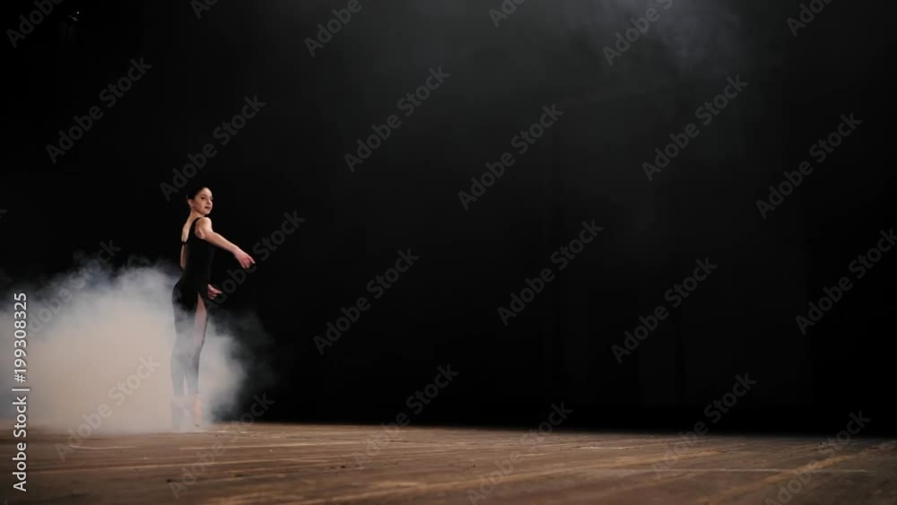 Young beautiful ballerina on smoke stage dancing modern ballet ...