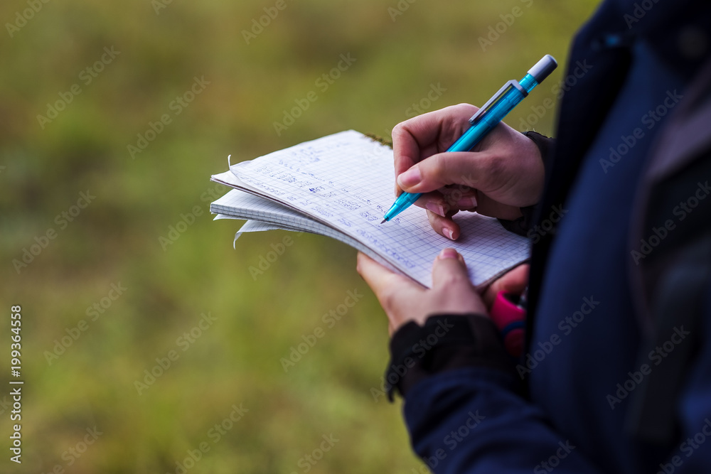 Environmentalist taking notes on field Stock Photo | Adobe Stock