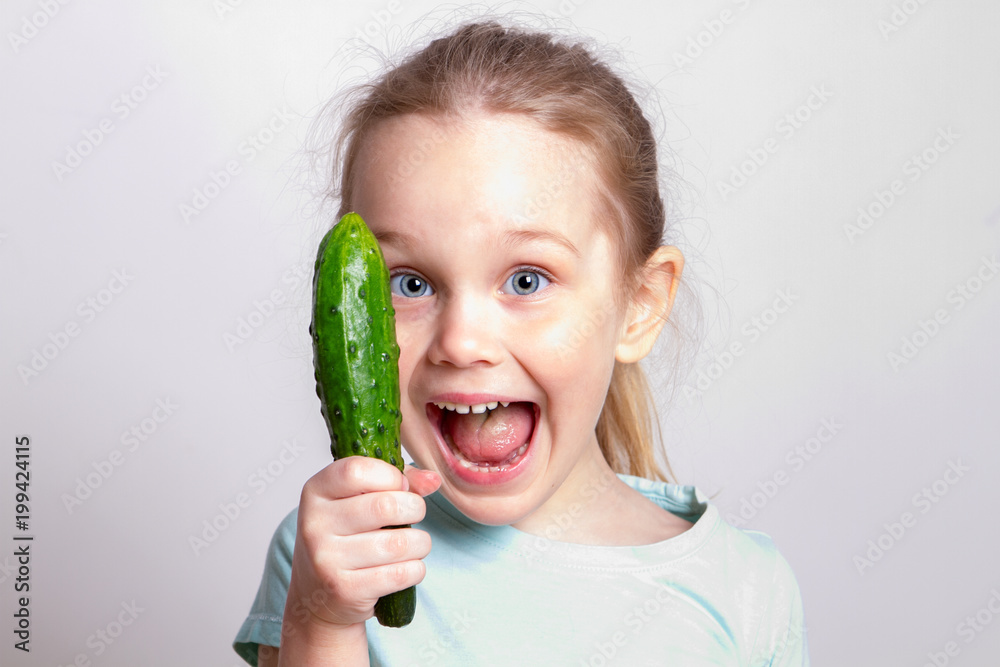 Funny image of little girl showing cucumber Stock Photo | Adobe Stock