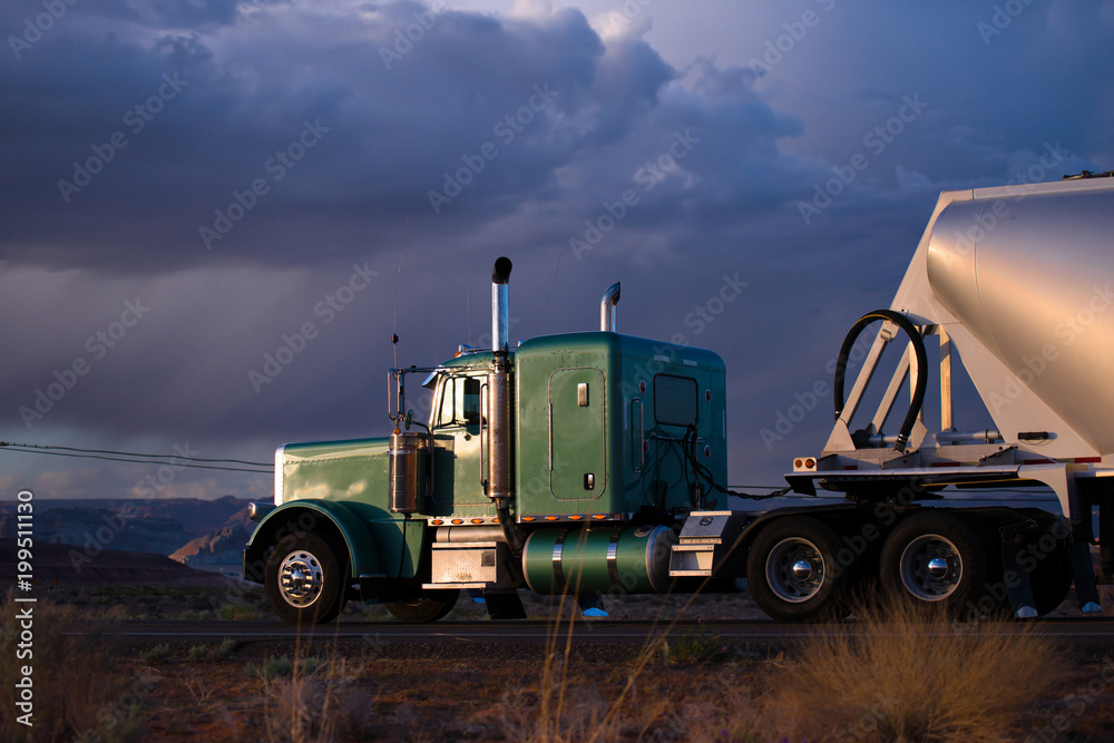 Big rig semi truck with bulk semi trailer carries cargo on the Arizona ...