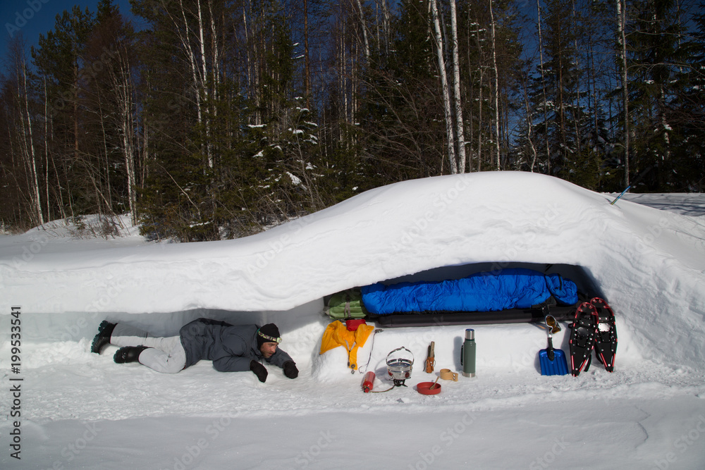 Man crawls into a snow cave. Entrance, sleep room, cross section. Stock ...