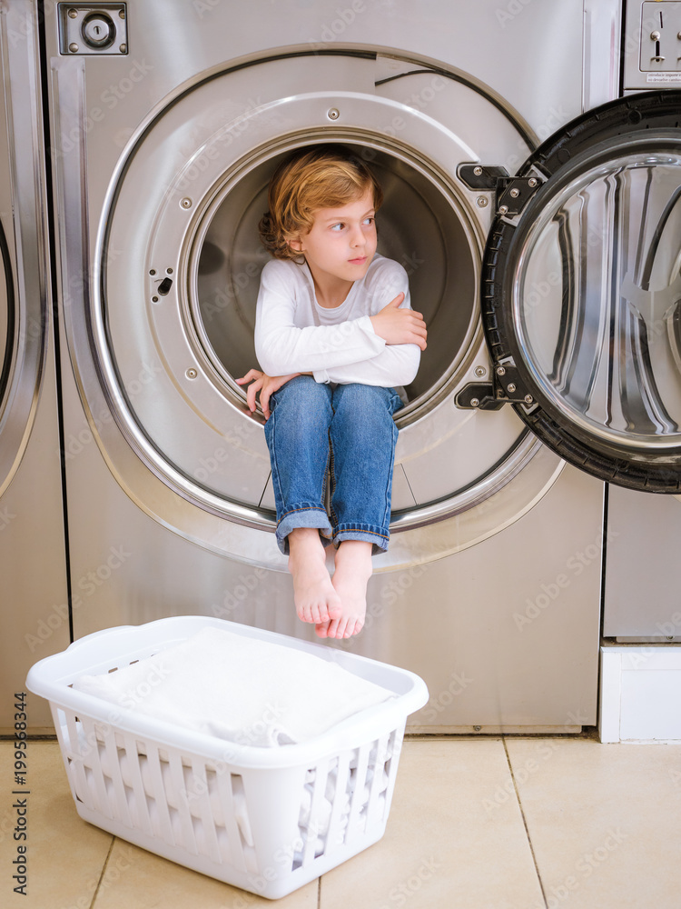 Young boy inside washing machine Stock Photo | Adobe Stock