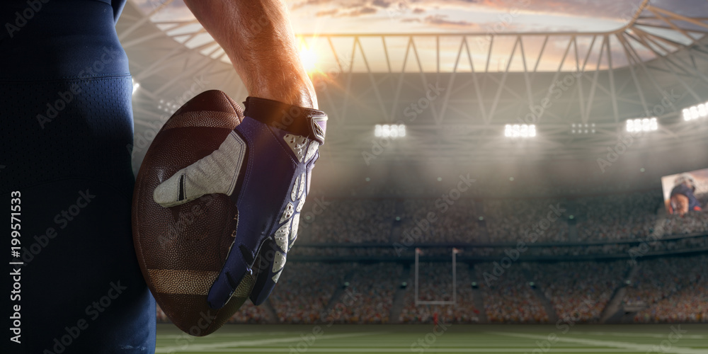 American football players hand with ball in professional sport stadium ...