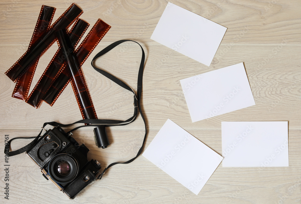 Retro camera and empty old instant paper photo album on wood table with ...