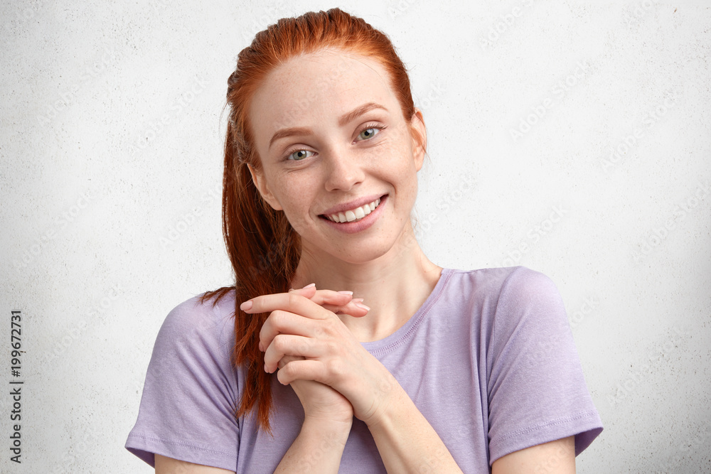 Pretty young woman with pleasant appearance, has positive expression ...