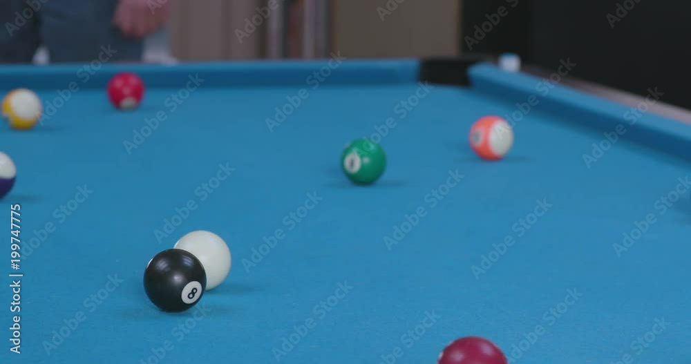 Man Breaking Racked Pool Balls in Eight-Ball Formation on Blue ...