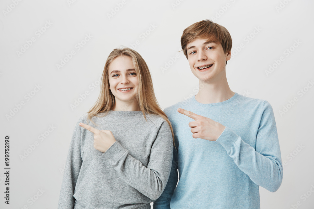 Funny friendly siblings showing direction to moms guest. Attractive ...