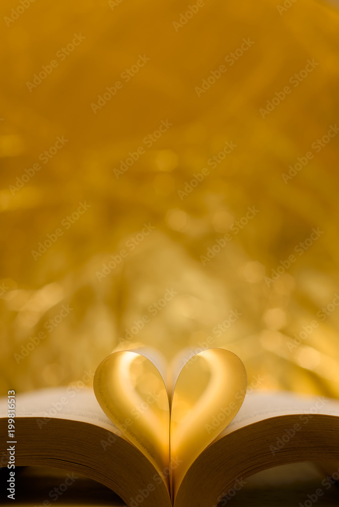 Heart-shaped paper inside a gold book. The shape of the heart is known ...