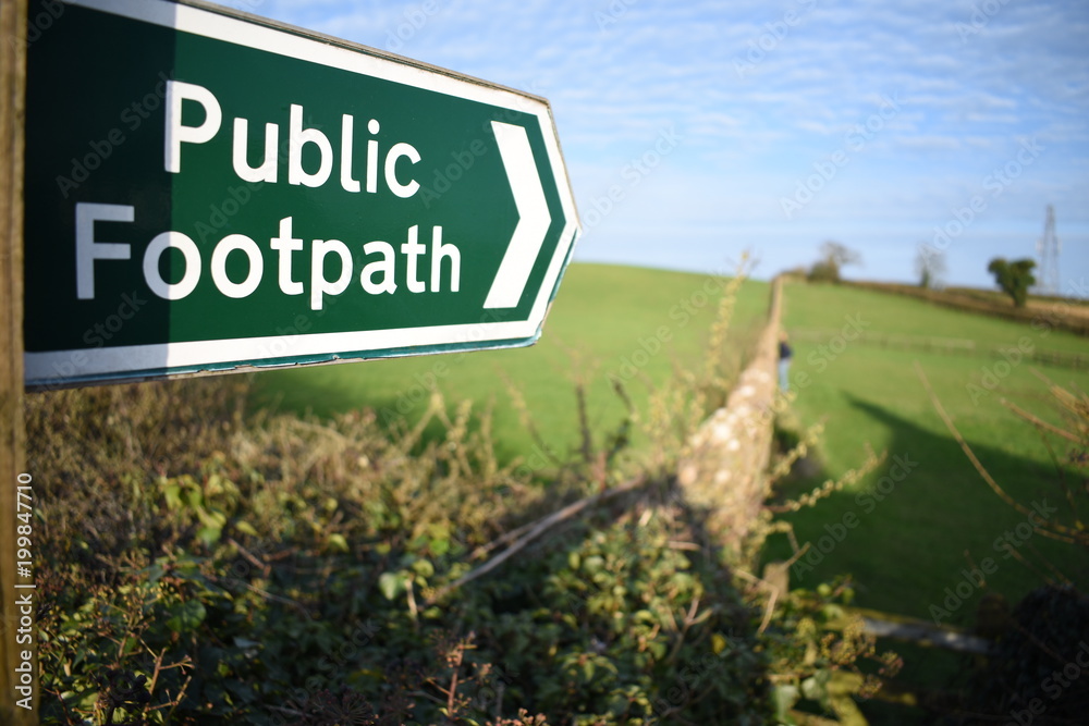 Closeup of a public footpath sign taken with a shallow depth of field ...