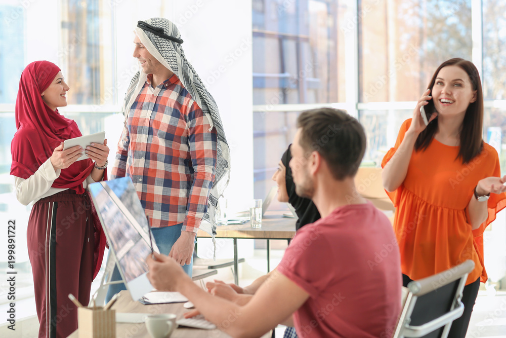 Office employees and their Muslim coworkers having business meeting in ...