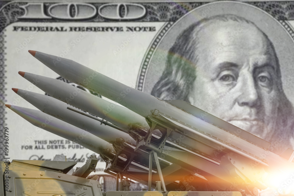 concept four rockets sent upwards against a hundred dollar banknote ...