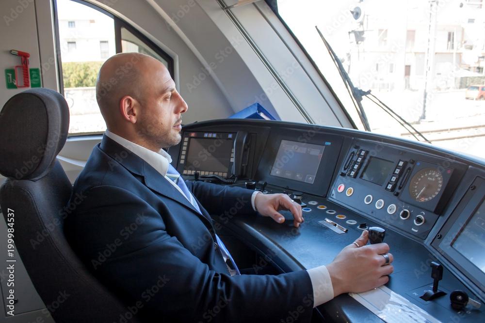 Train driver in cabin Stock Photo | Adobe Stock