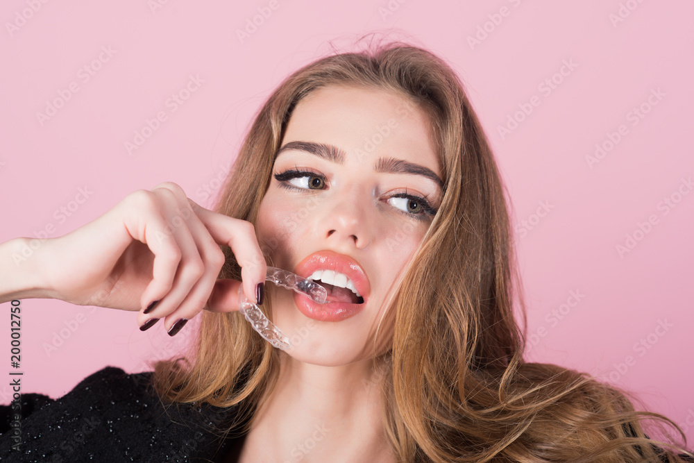 Teeth retainer for improving bite in hand of pretty girl. Teeth care ...