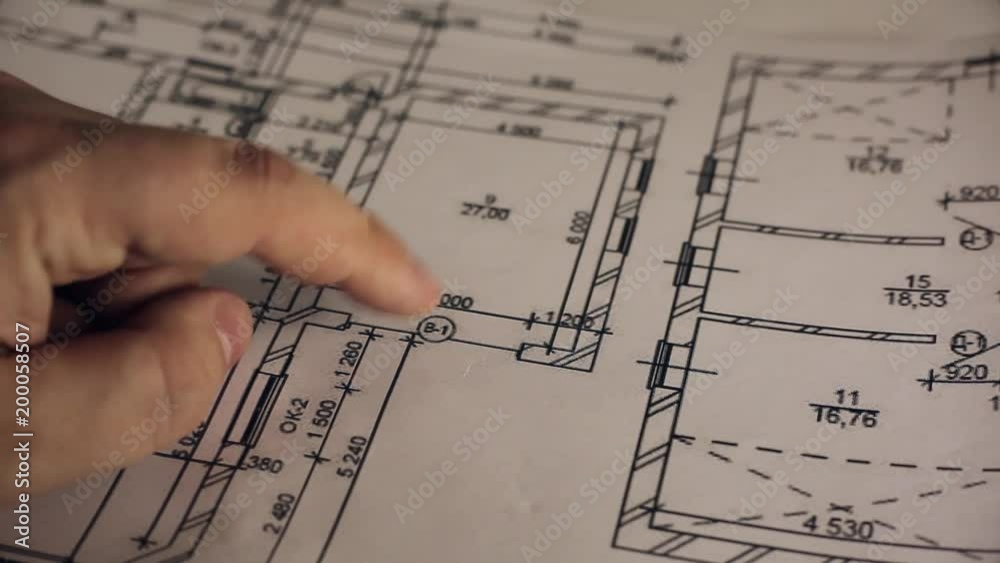 Male engineer checks the construction drawings. House plan. Closeup ...