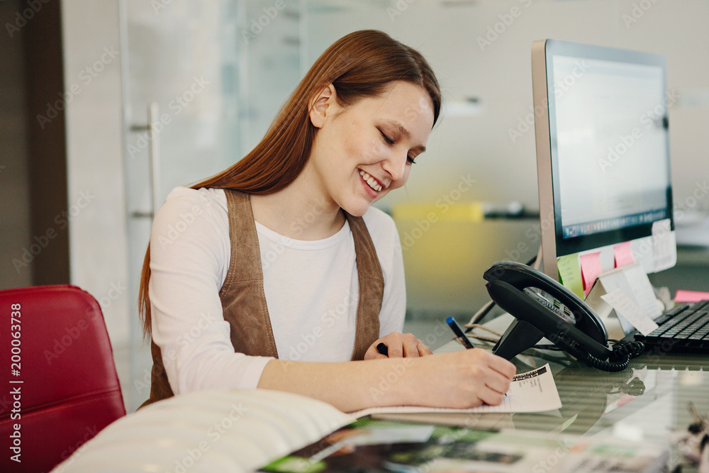 Beautiful woman fills a form in the office. Stock Photo | Adobe Stock
