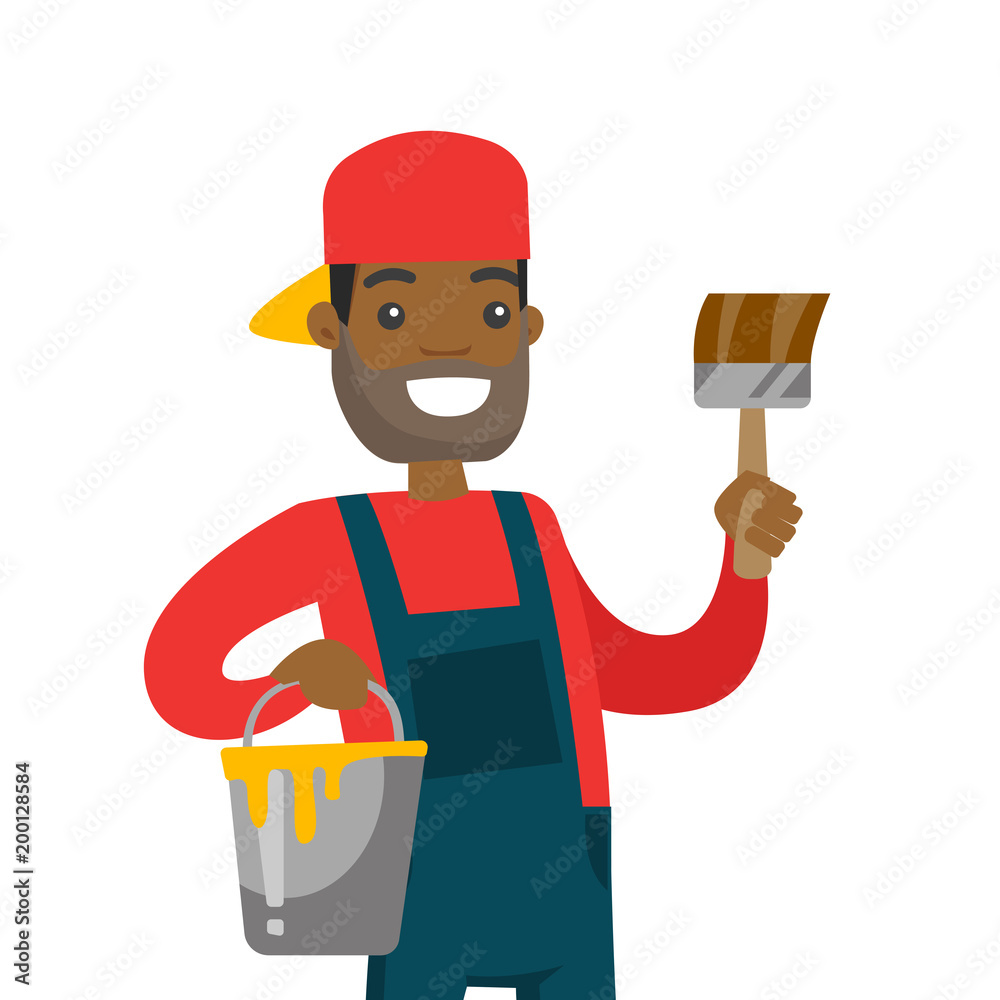 Young cheerful african-american house painter holding a paintbrush and ...