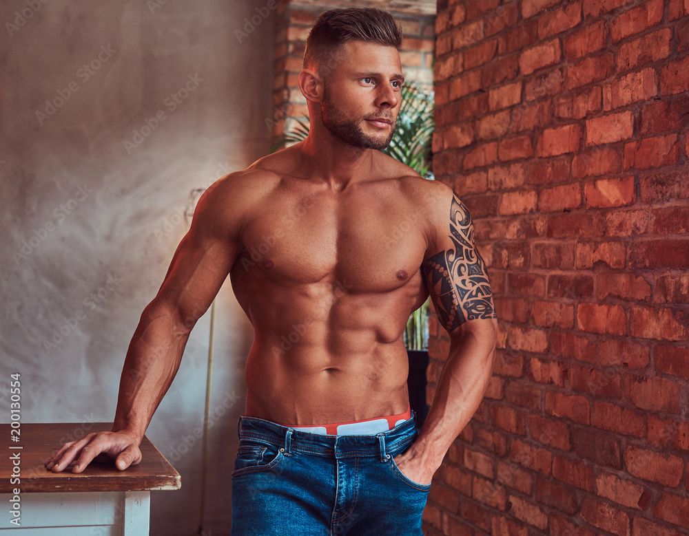 Portrait of a strong handsome shirtless male with muscular body ...