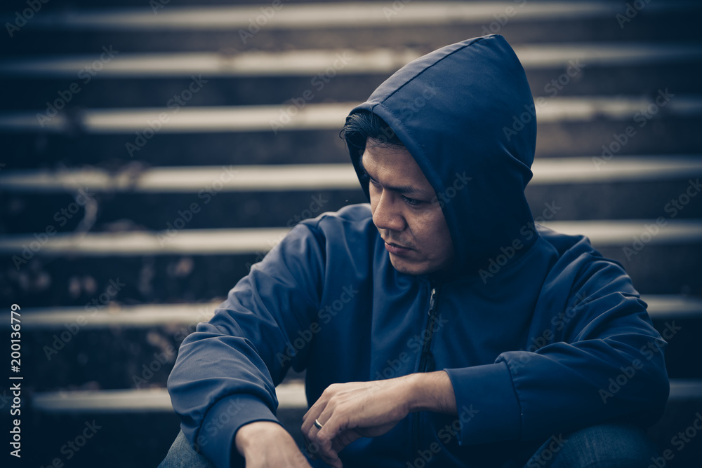 Foto de Portrait of asian man sad,drug addict man sitting on the floor ...