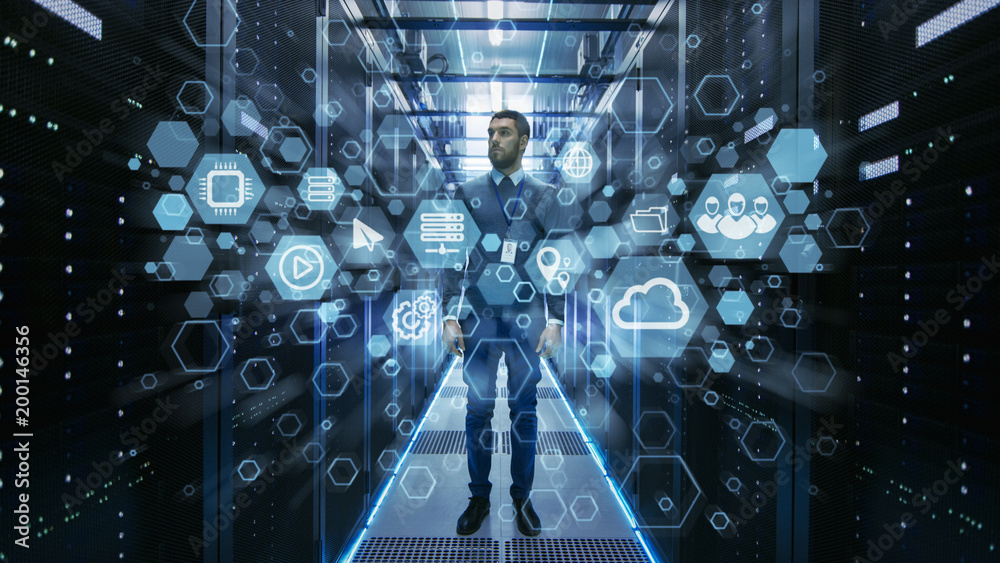 Curios IT Engineer Standing in the Middle of a Working Data Center ...