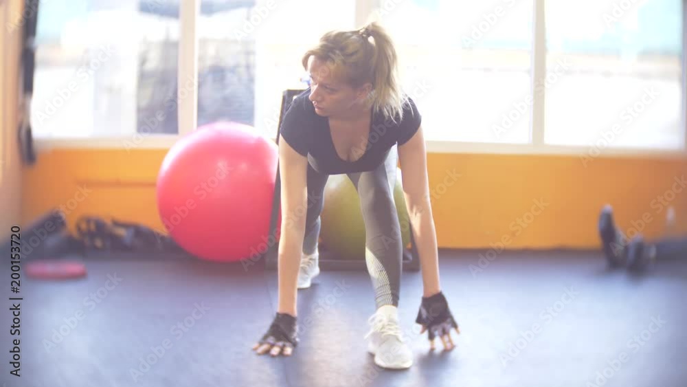 Woman working out in gym. 4k, background blur Stock Video | Adobe Stock