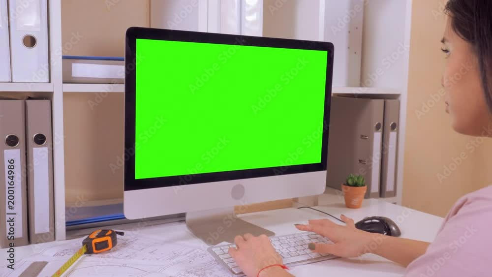 back view woman with black long hair sitting at the workplace working ...