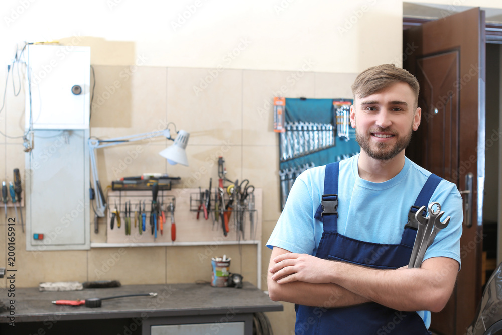 Mechanic with tools in garage. Tire and other car services Stock Photo ...