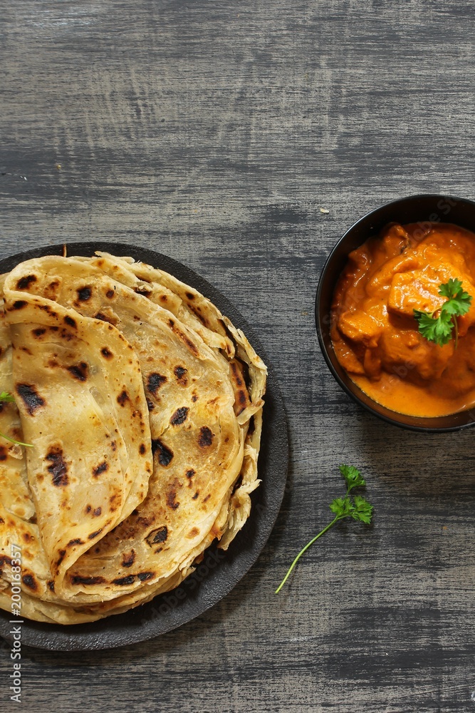 Homemade Kerala wheat paratha or layered parotta served with Paneer ...