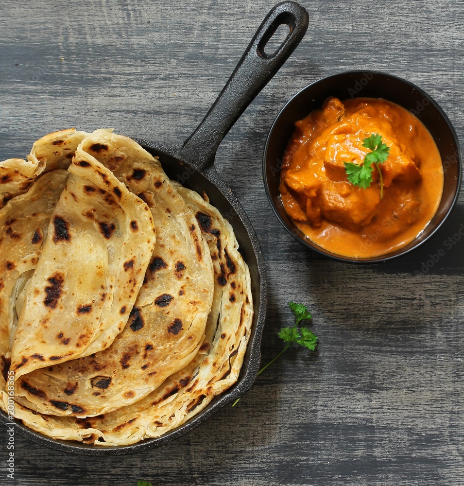 Homemade Kerala wheat paratha or layered parotta served with Paneer ...