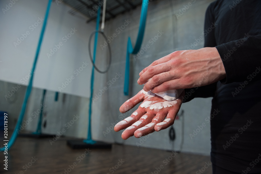 Gymnast rubbing chalk powder on her hands Stock Photo | Adobe Stock