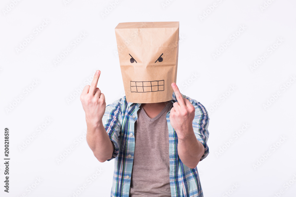 Man with cardboard box on his head and drawing of angry emoticon face ...
