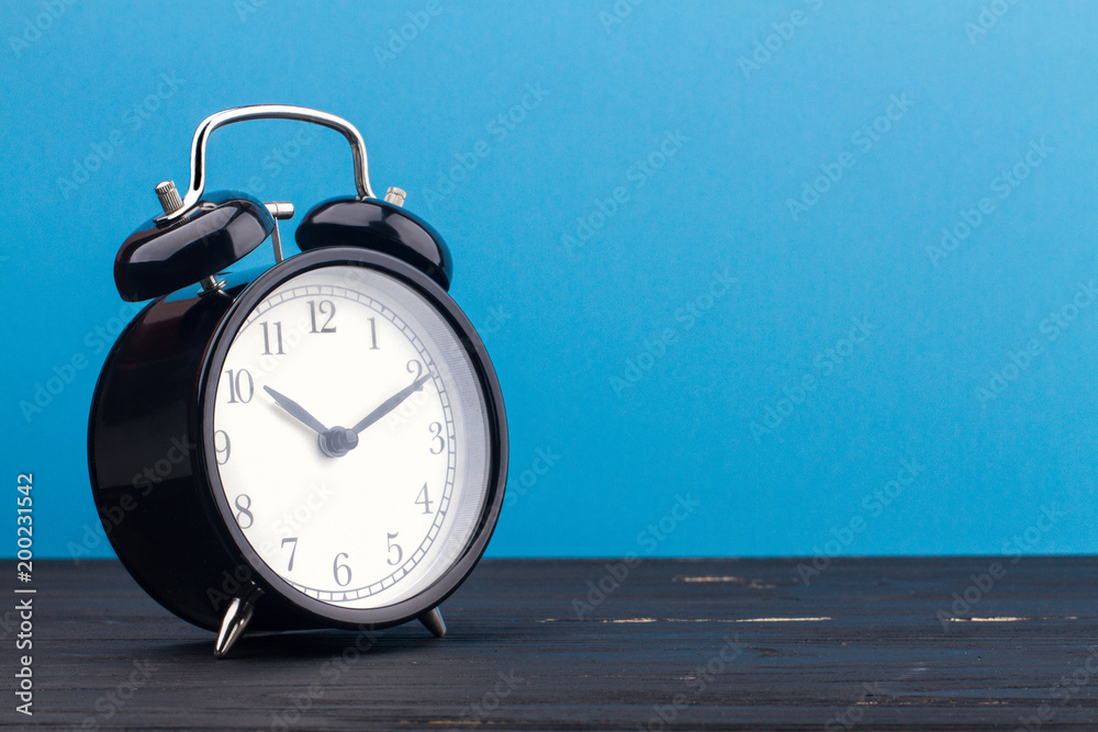 alarm clock wooden plank colored background Stock Photo | Adobe Stock