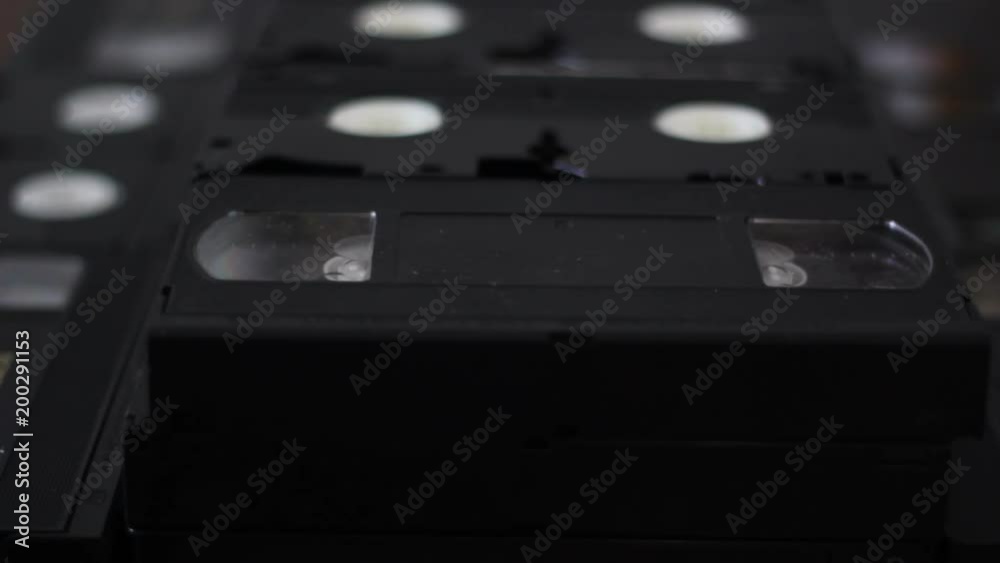 Put and take a vhs tape from a stack of tapes Stock Video | Adobe Stock