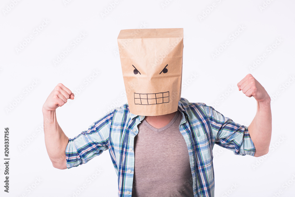 Man with cardboard box on his head and drawing of angry emoticon face ...