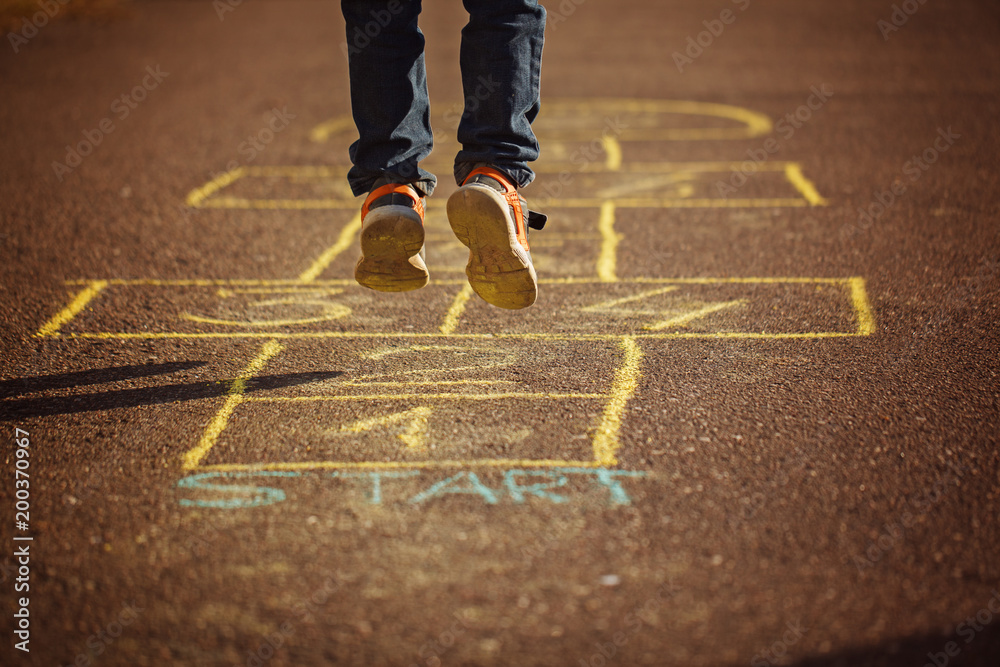 Kids playing hopscotch on playground outdoors. Hopscotch popular street ...