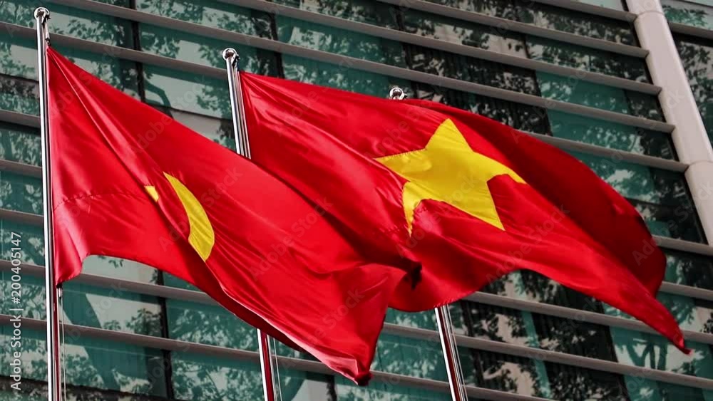 The red flag with communist symbols of a sickle and a hammer flying by ...