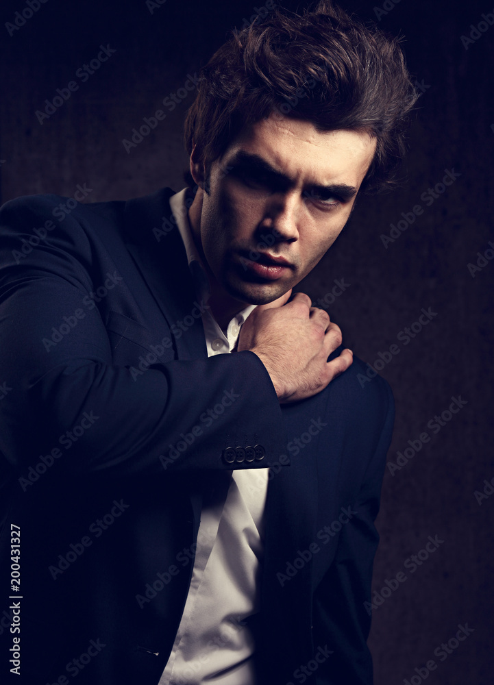 Sexy serious business man posing in blue suit and white style shirt ...