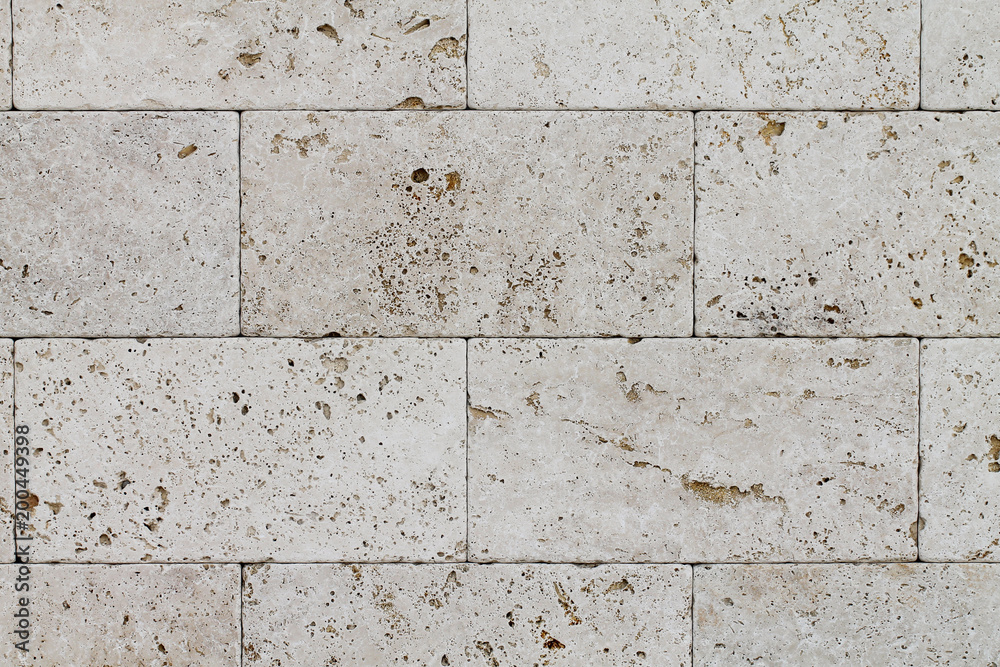 Natural Italian stone. Smooth travertine surface. A sample of wall ...