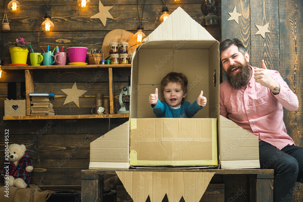 Rocket launch concept. Kid happy sit in hand made rocket. Boy play with ...