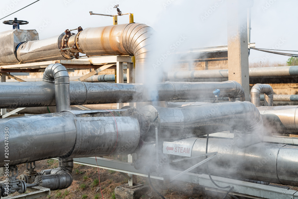 Leakage of steam in heat pipeline interior industrial gas with a lot of ...