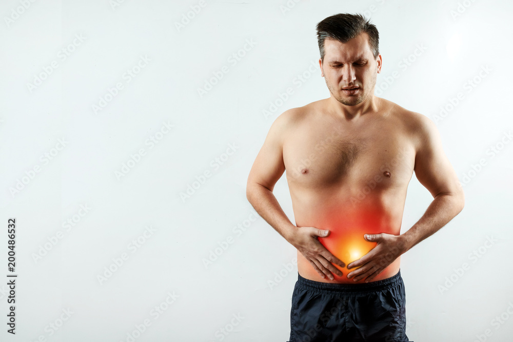 Front view, the man holds his hands to the stomach, abdominal pain ...