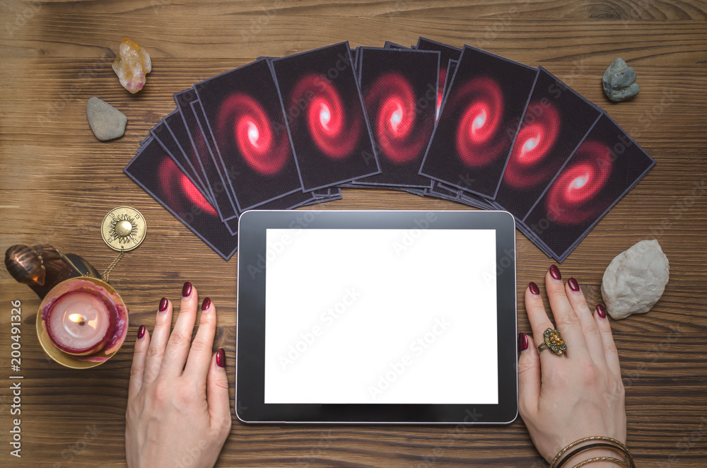 Online future reading concept. Tarot cards and tablet computer with ...