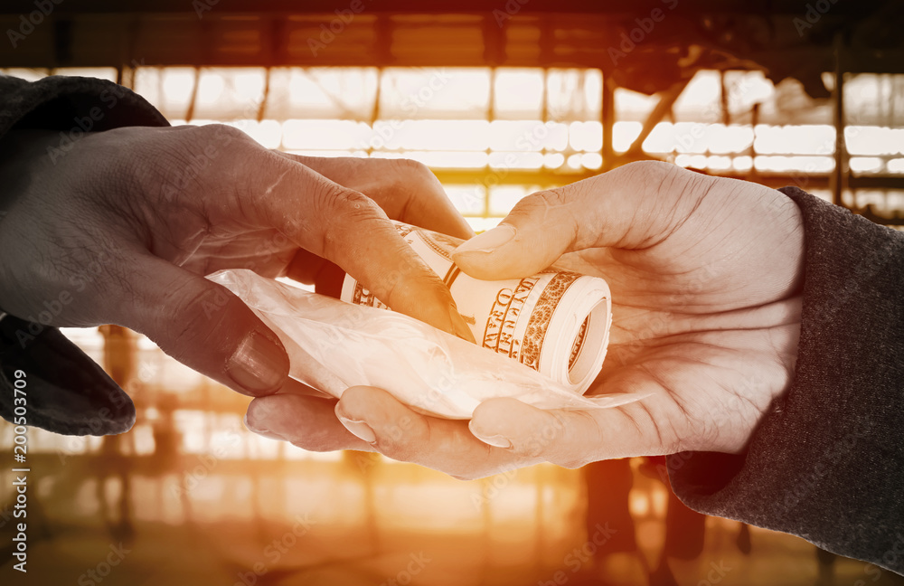 Foto de Drug trafficking, crime, addiction.Addict with money buying ...