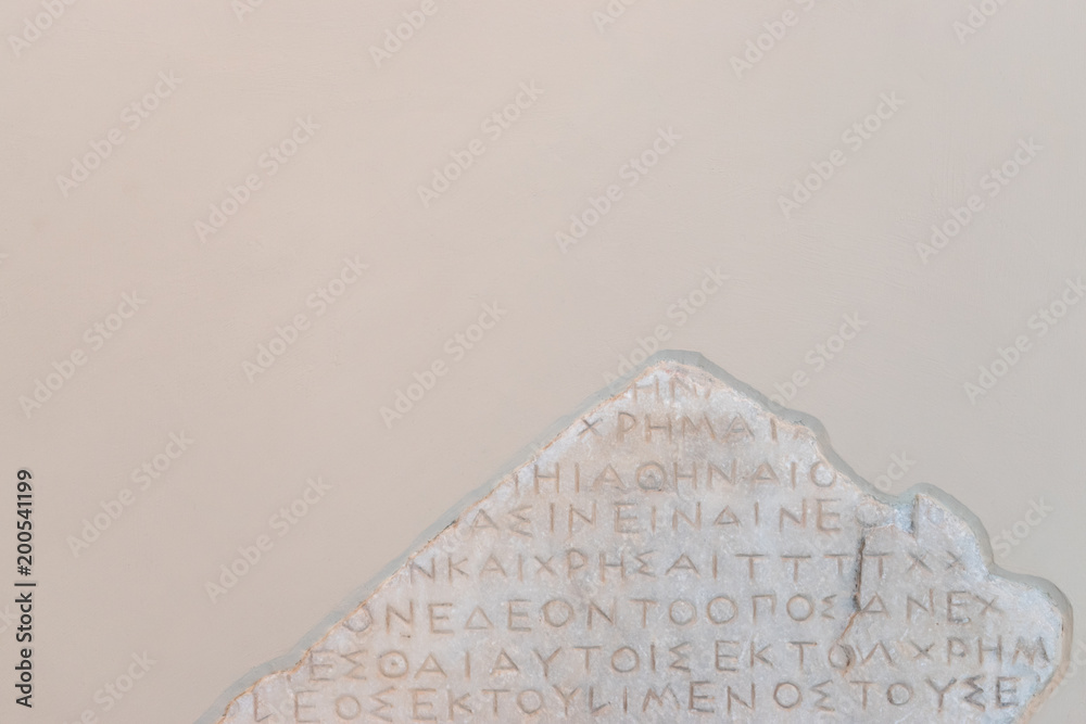 Ancient greek words carved into stone with cracked. For texture and ...