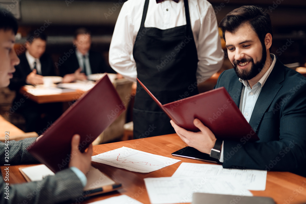 Meeting with chinese businessmen in restaurant. Two men are making ...