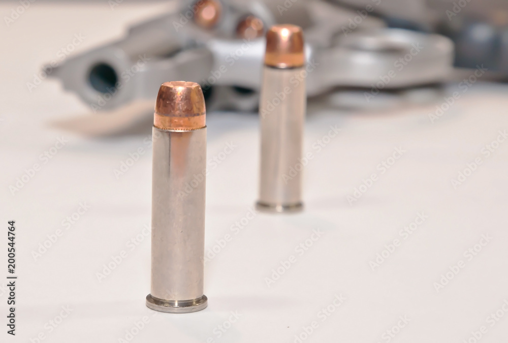 Two .357 magnum bullets with a stainless loaded revolver in the ...